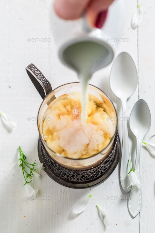 Pouring milk into tea with filigree holder Stock Photo by Shaiith ...