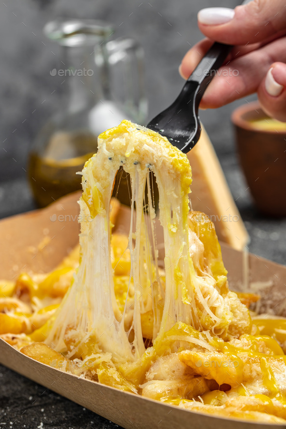 Cheddar Cheese Poured on top Deep Fried French Fries, Fast food take ...