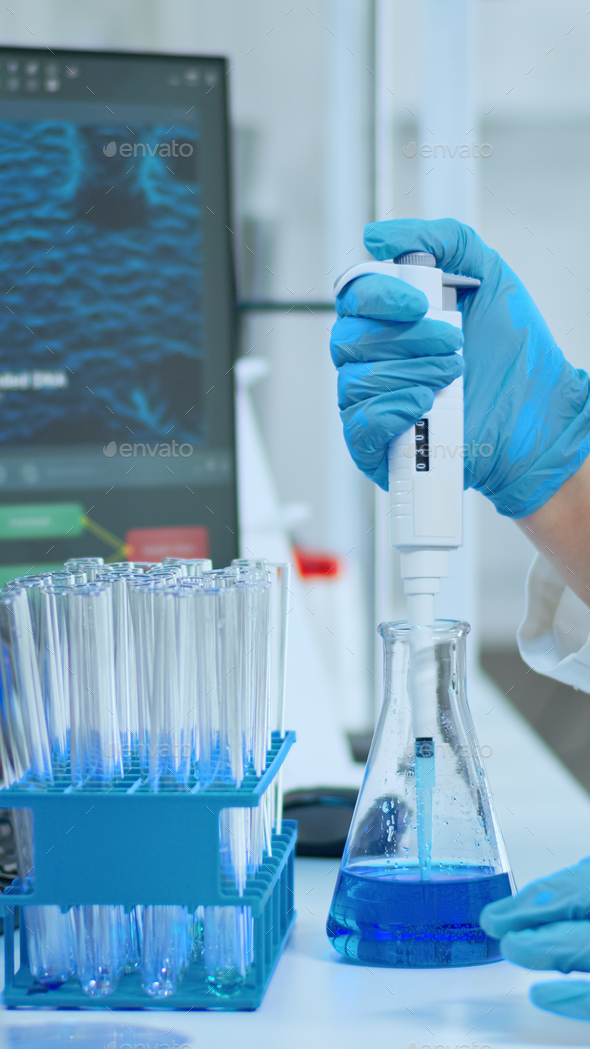 Close up of researcher testing liquid sample using micropipette Stock ...