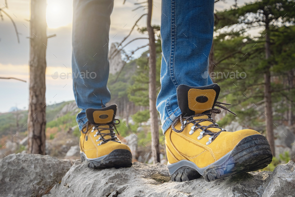 hiking boots close up. female tourist steps on the stone Stock Photo by ...