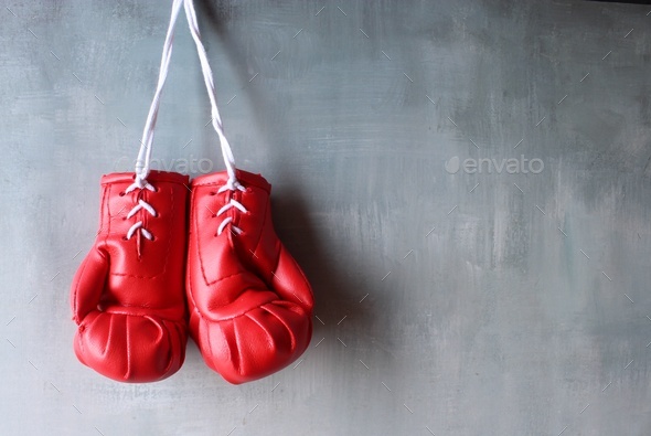 Red boxing gloves hang on wall with copy space Stock Photo by ...
