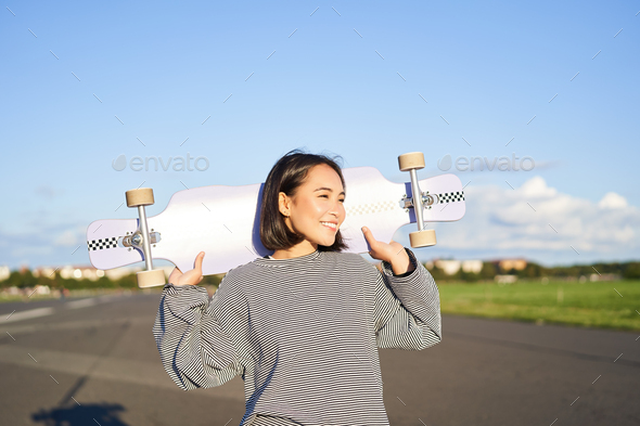 Lifestyle and people. Young asian girl posing with longboard, skating ...