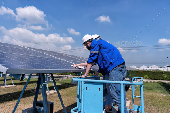 Maintenance engineer at solar farm stand on scissor lift routine ...