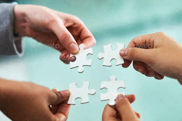 Connected as one. Shot of hands putting puzzle pieces together. Stock ...