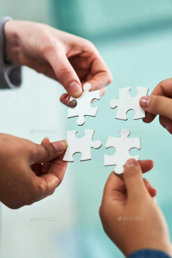 Joining together to see the bigger picture. Shot of hands putting ...