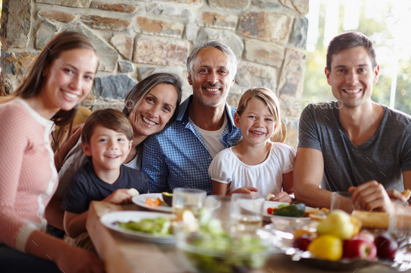 A portrait of a happy multi-generational family having a meal together ...