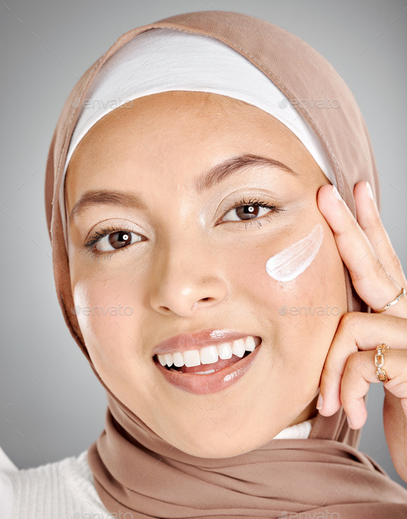 Skincare, hijab and muslim woman with a smile using beauty cream ...