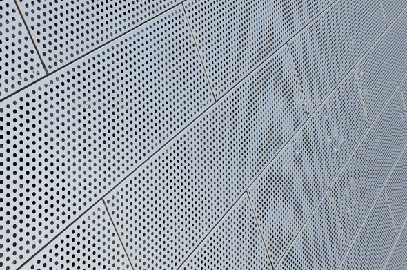 Diagonal view of metal dot pattern pannels on ceiling background Stock ...