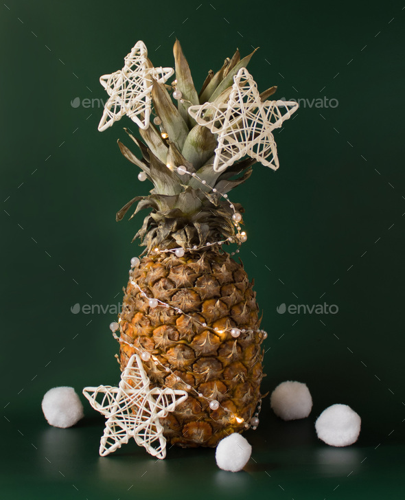 Christmas decor concept with pineapple, white wicker stars and ...