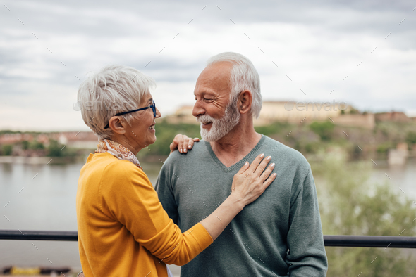 Mature couple, reminiscing about their life together. Stock Photo by bnenin