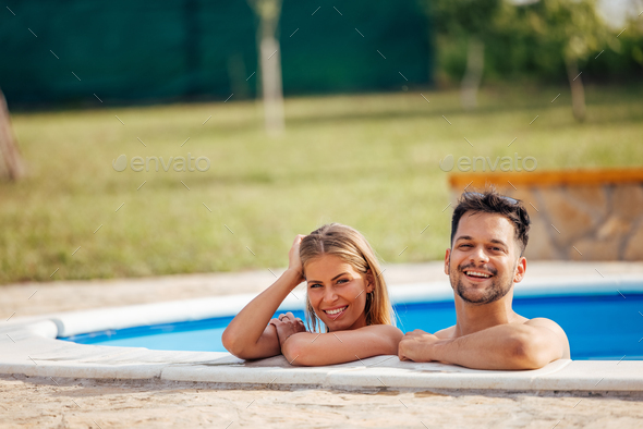 Adult people, relaxing at the swimming pool. Stock Photo by bnenin