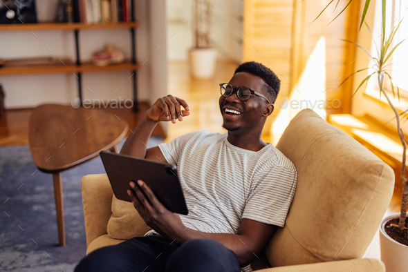 Adult black man, socializing with his coworkers. Stock Photo by bnenin