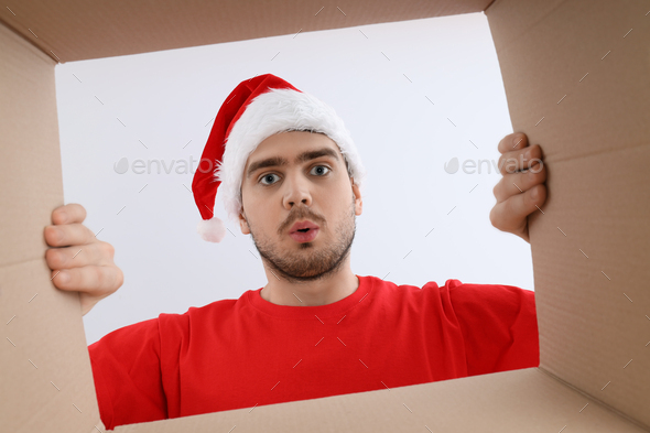 Concept Of Delivery T Surprise Young Man Look In To Cardboard Box