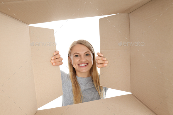 Concept of delivery, young woman look in to box, isolated on white ...