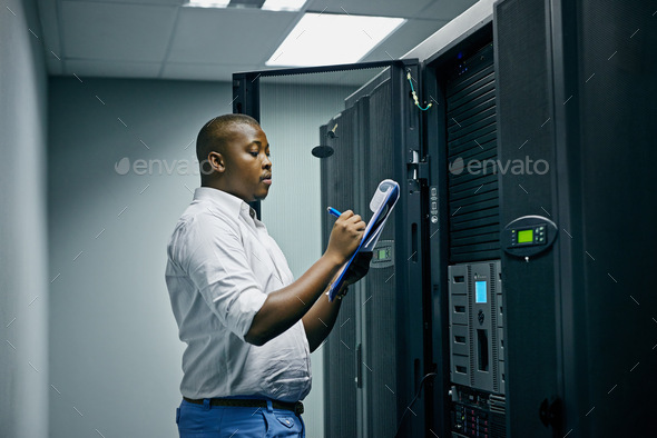 Shot of an IT technician doing inspections in a data center Stock Photo ...