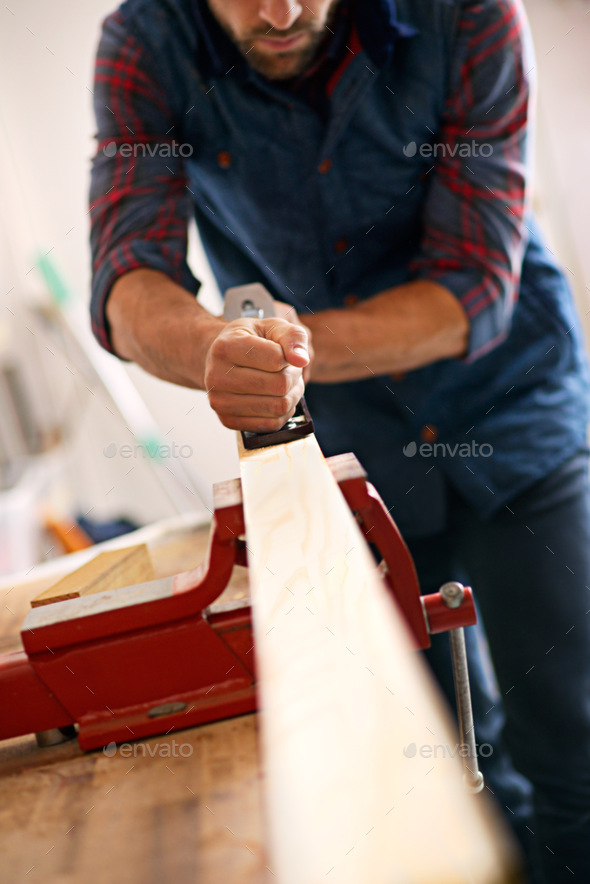 Precision and perfection. Shot of a handsome young carpenter measuring ...