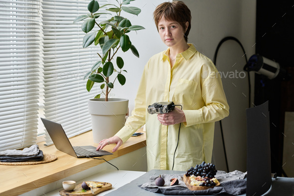 Photographer photographing still life on table Stock Photo by AnnaStills