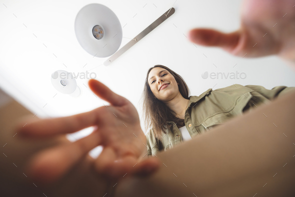 View from inside the box, woman grabbing something from inside the box ...