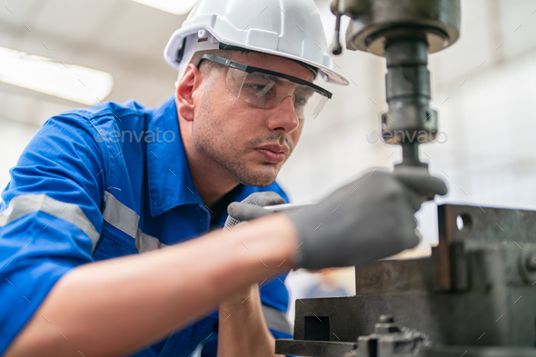 Robotics engineer fitting sensors to traditional engineering lathe in ...