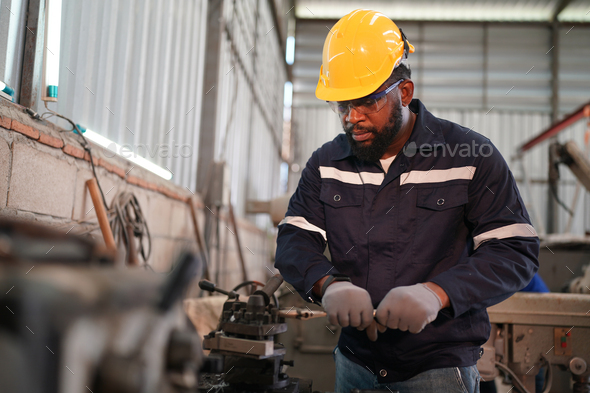 Robotics engineer fitting sensors to traditional engineering lathe in ...