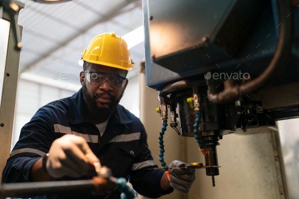 Robotics engineer fitting sensors to traditional engineering lathe in ...