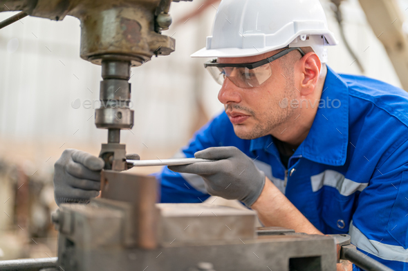 Robotics engineer fitting sensors to traditional engineering lathe in ...