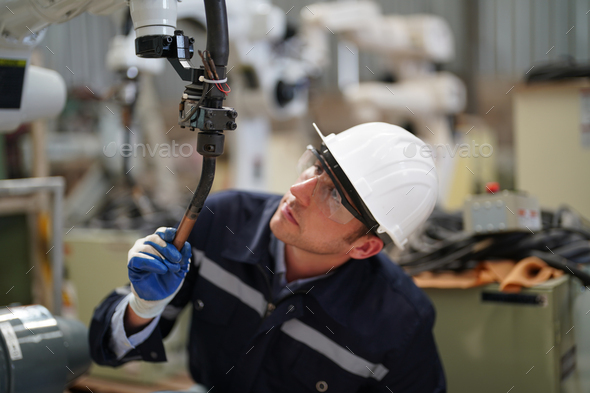 Robotics engineer fitting sensors to traditional engineering lathe in ...