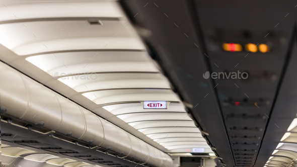 Exit sign in passenger airplane. Emergency exit sign on airplane. Exit ...