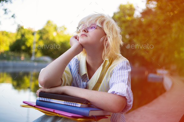 Photography with teenage girl sitting with her work books and folders ...