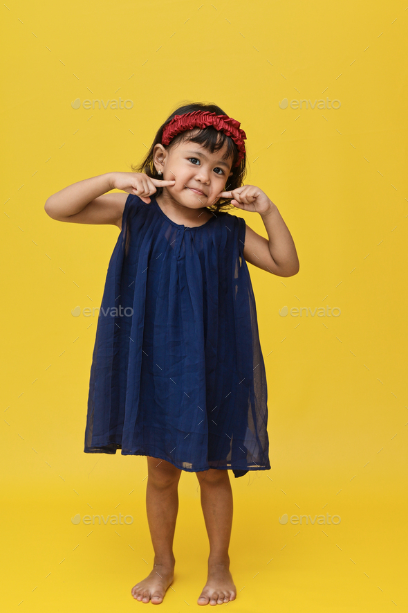 Smiling cute little girl showing cheeks Stock Photo by Queenmoonlite35