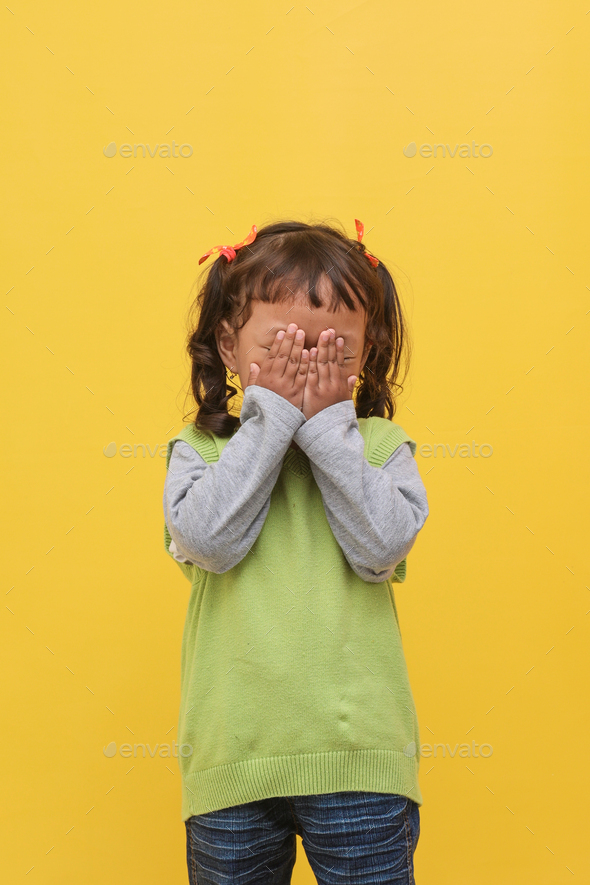 Cute little girl playing peek a boo Stock Photo by Queenmoonlite35