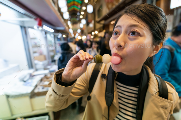 female eating Japanese dango on teramachi street Stock Photo by ...
