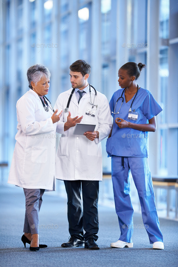 Making an informed decision. A medical team standing in the hospital corridor. Stock Photo by ...
