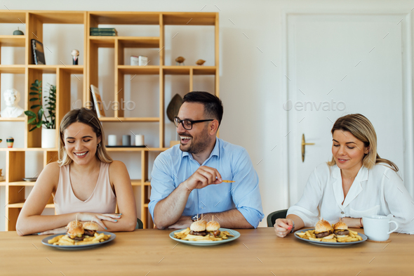 Coworkers having fun on lunch break, portrait. Stock Photo by bnenin