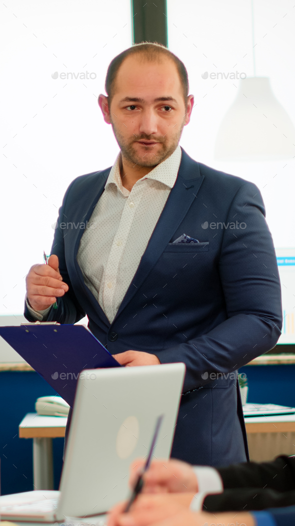 Executive manager presenting sales reports Stock Photo by DC_Studio