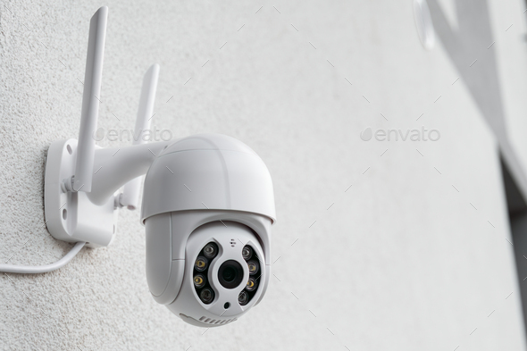Round CCTV camera with antennas shoots video on the white wall Stock ...