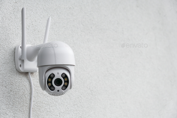 Round CCTV camera with antennas shoots video on the white wall Stock ...