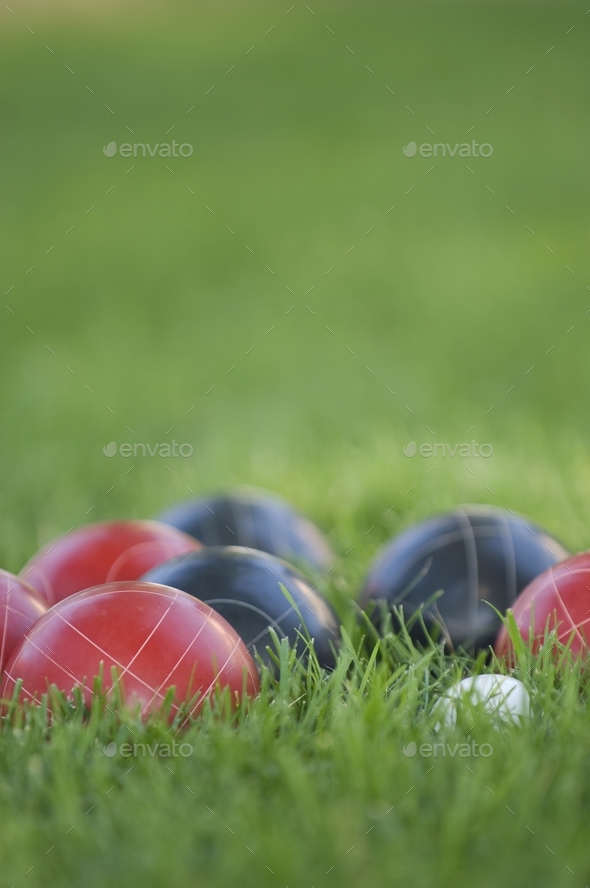 Vertical picture of colourful bocce balls on the lawn under the ...