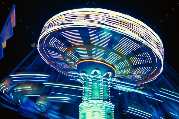 Carousel with bright lights of different colors in a rotary motion ...