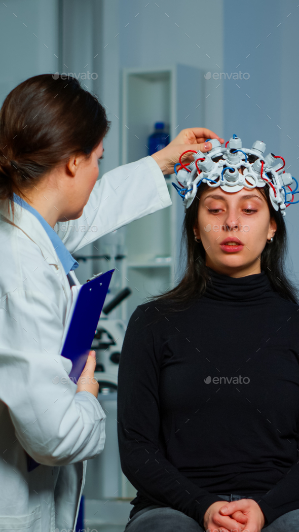 Neurological doctor cheking eeg headset explaining treatment Stock ...