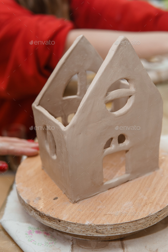 Women's hands knead clay, drawing elements of the product. Production ...