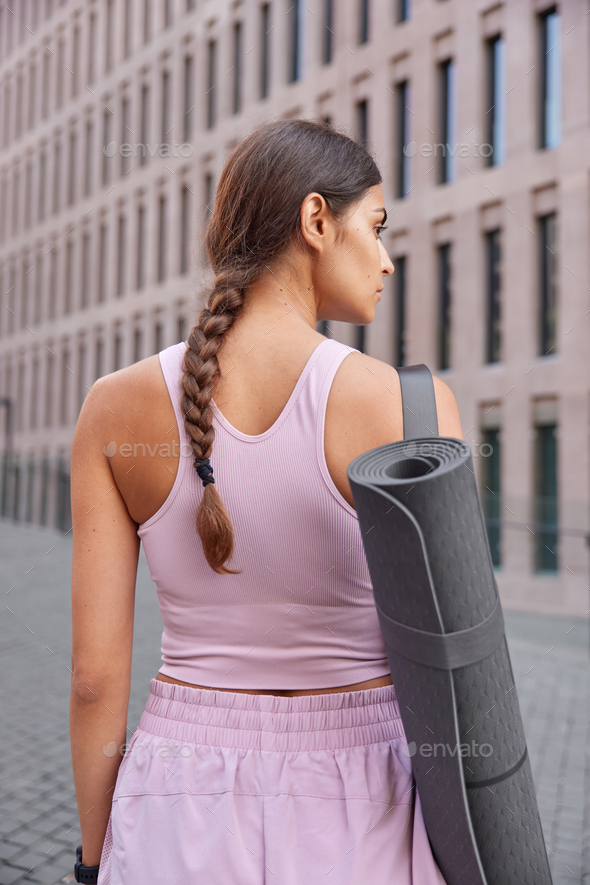 Back view of sporty woman with slim body dressed in sportsclothes has ...