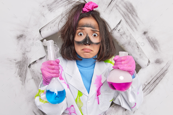 Serious displeased female scientist poses with scientific samples in ...