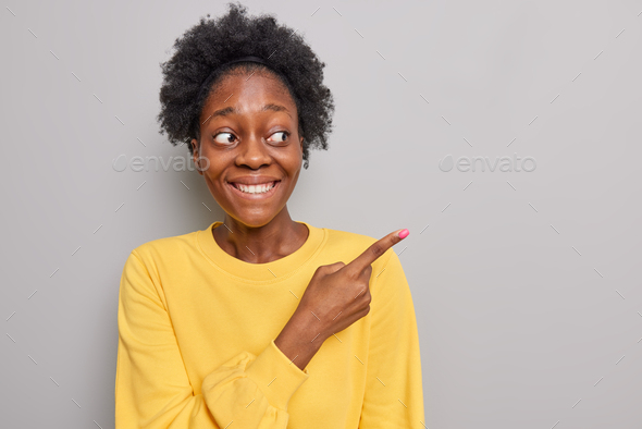 Look at this. Dark skinned young woman with curly hair smiles broadly ...