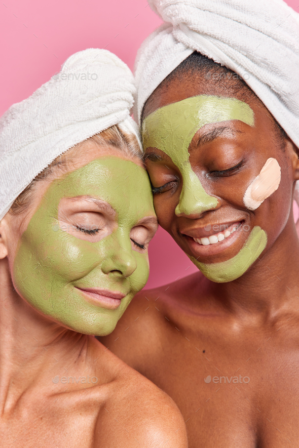 Vertical shot of multiethnic women of different age apply green natural ...