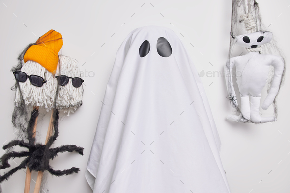Horizontal shot of scary ghost stands indoor against creepy handmade ...