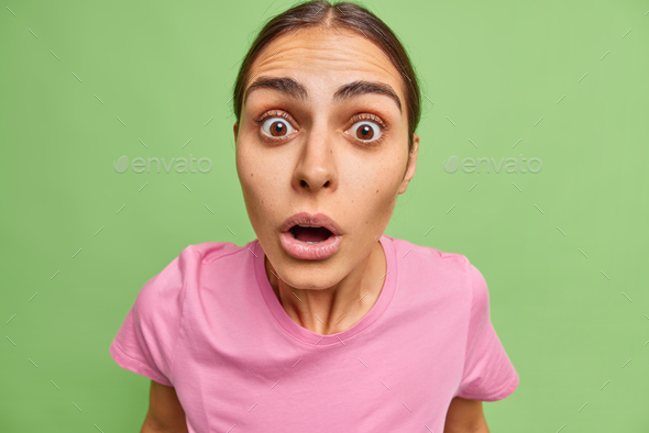 Close up portrait of startled emotional young woman has bated breath ...