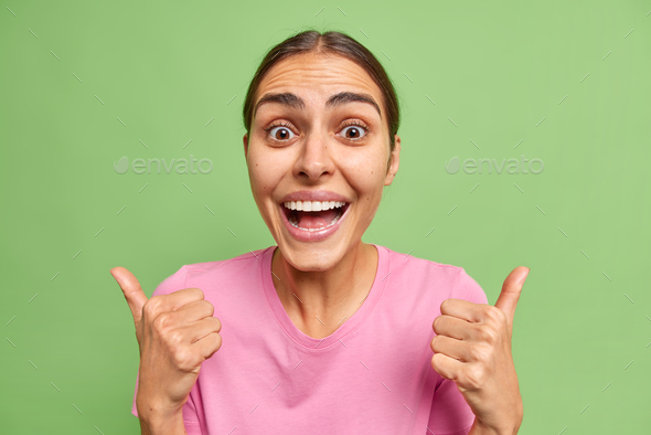 Photo of charming positive young European woman smiles broadly shows ...