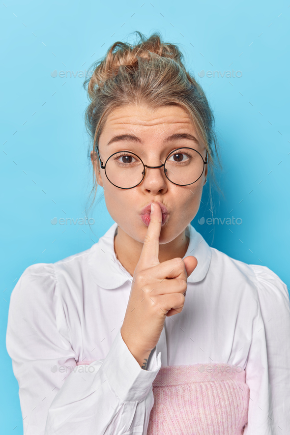 Image of pretty mysterious woman presses index finger over lips makes ...