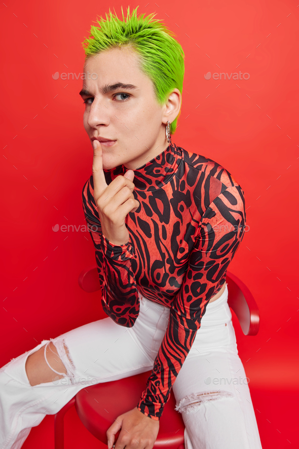 Attentive serious punk teenager has own style of clothes and appearance ...